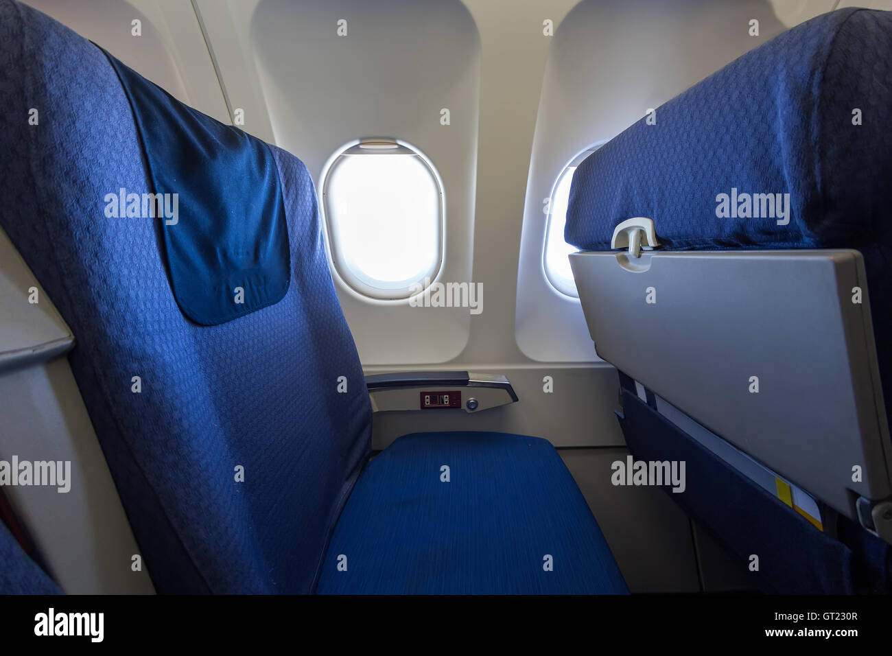 Airplane seat and window inside an aircraft. Image with shallow depth ...