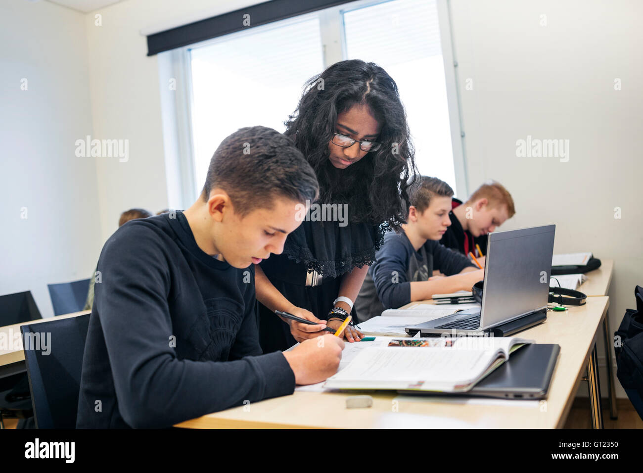 Schoolchildren (12-13, 14-15) in classroom Stock Photo - Alamy