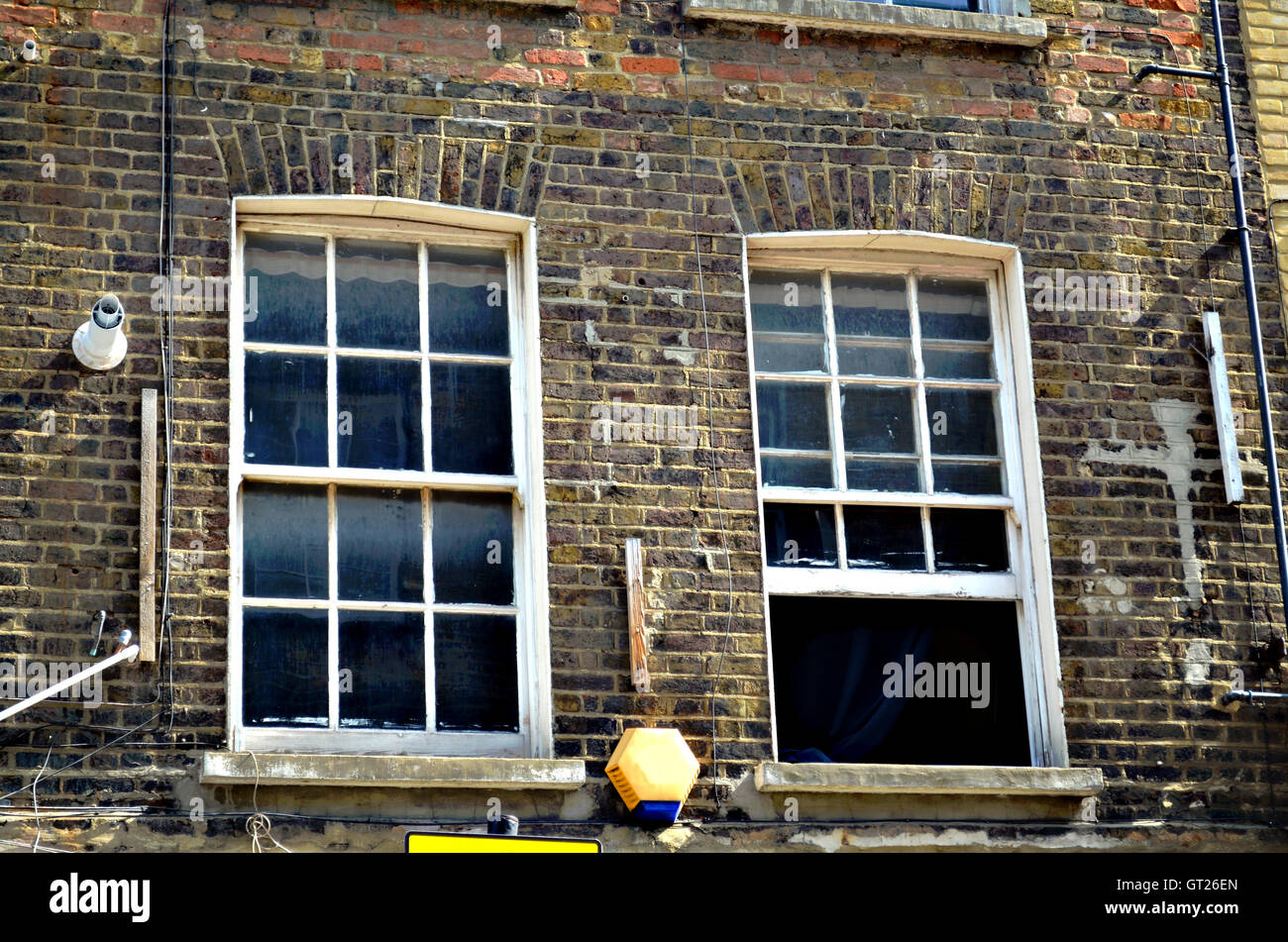 two typical British windows in a brick wall opened and closed, Uk ...