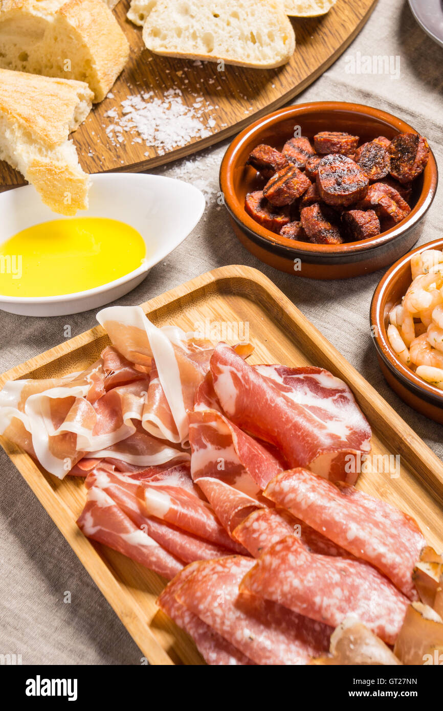 Tapas food, served in small bowls cold meat, goat cheese. A meal for ...