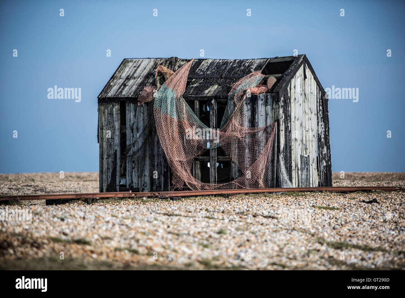 A derelict wooden hut on a shingle beach Stock Photo - Alamy