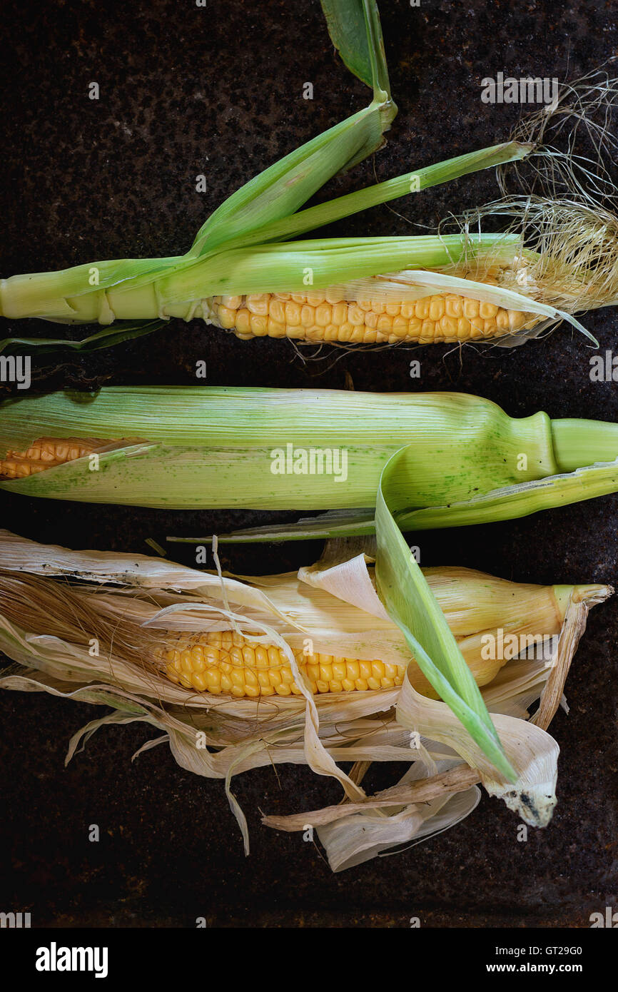 Corn cobs with leaves Stock Photo - Alamy