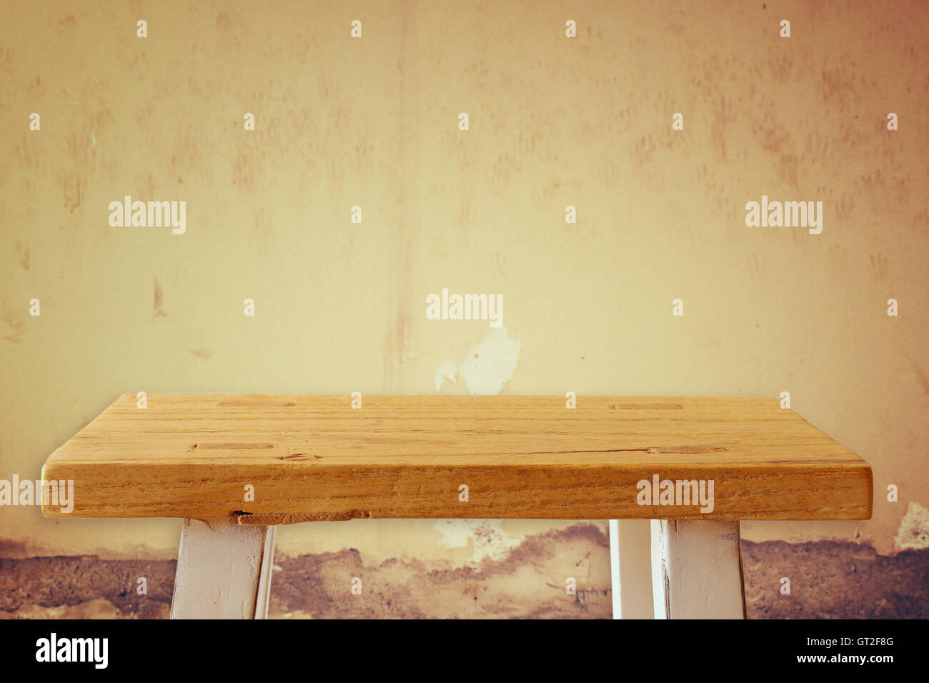 Empty small table in front of old wall background. For product display ...