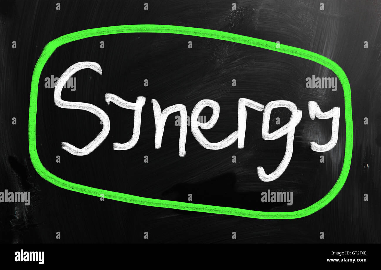 The word "Synergy" handwritten with white chalk on a blackboard Stock ...