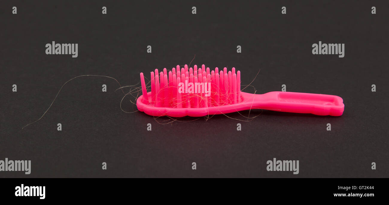 Pink toy brush with hair Stock Photo - Alamy