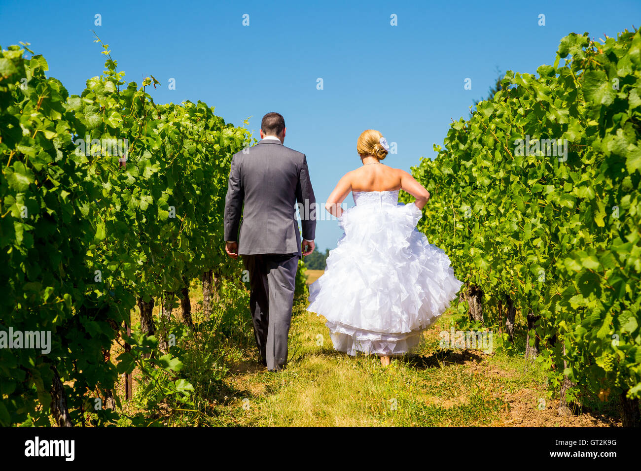 Bride and Groom Walking Away Stock Photo - Alamy