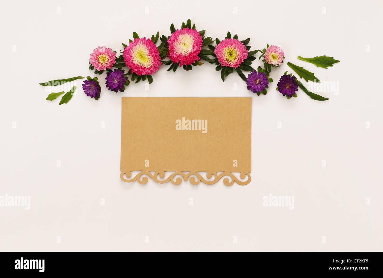 Top view of beautiful flowers and blank note on white background. Copy ...