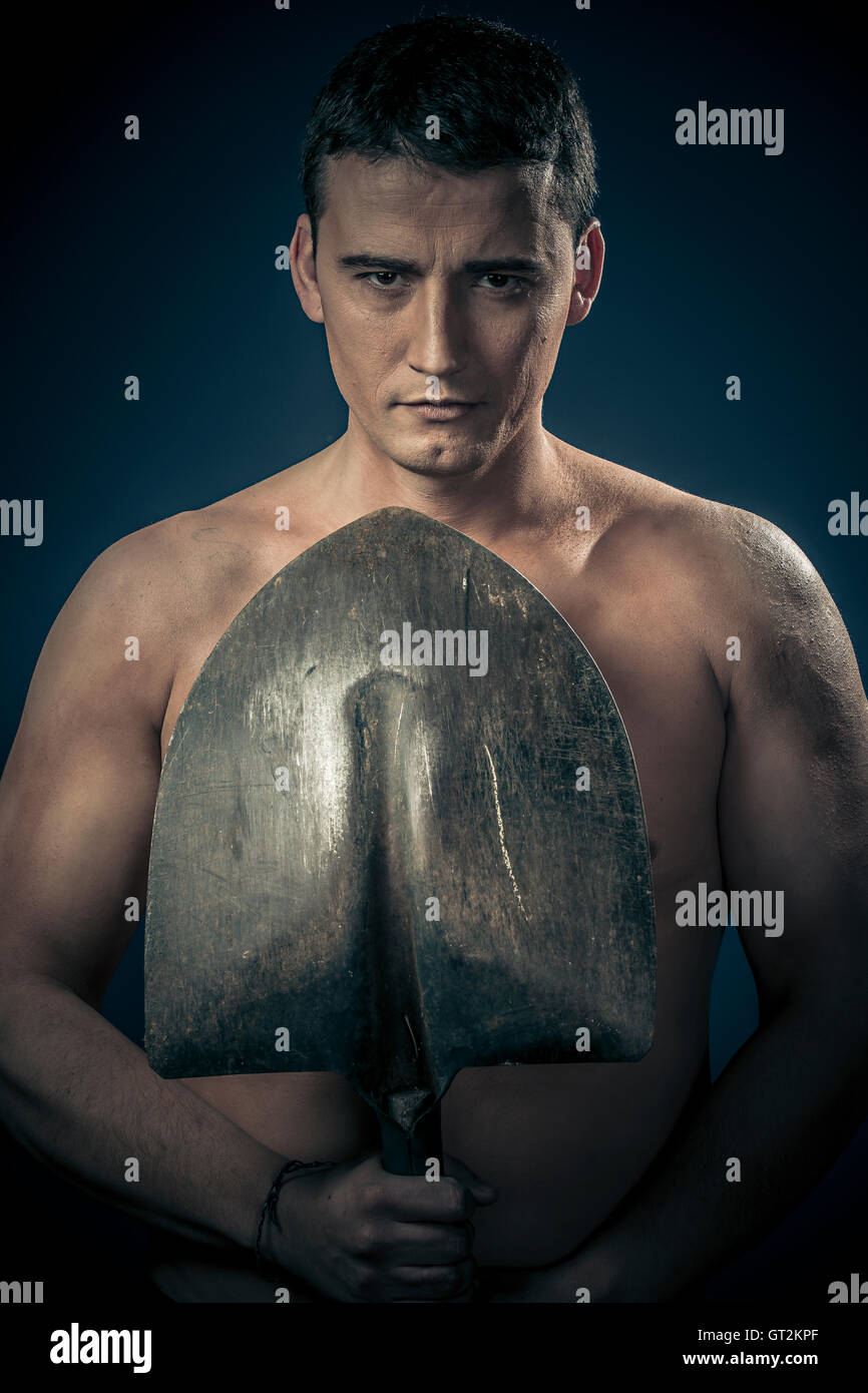 strong man with shovel, construction worker Stock Photo - Alamy