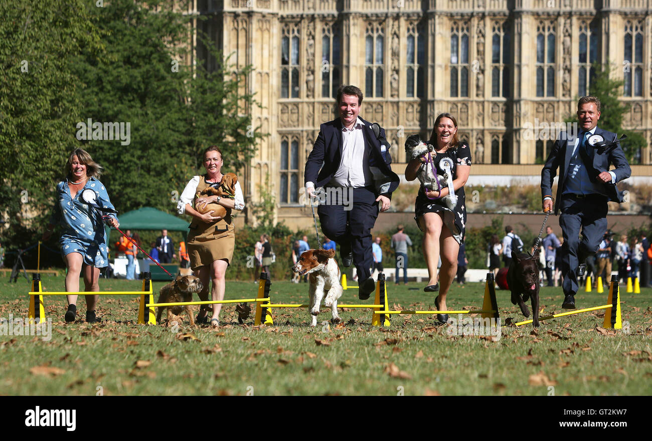 EDITORIAL USE ONLY MPs and their dogs tackle an agility jump at the ...