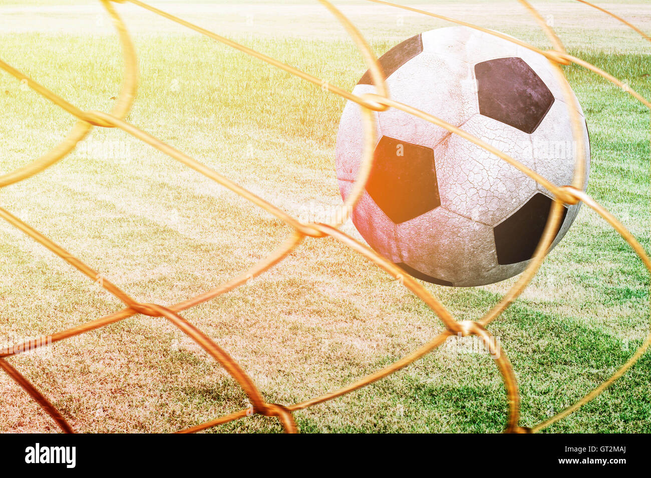 Soccer ball inside the net of stadium Stock Photo - Alamy