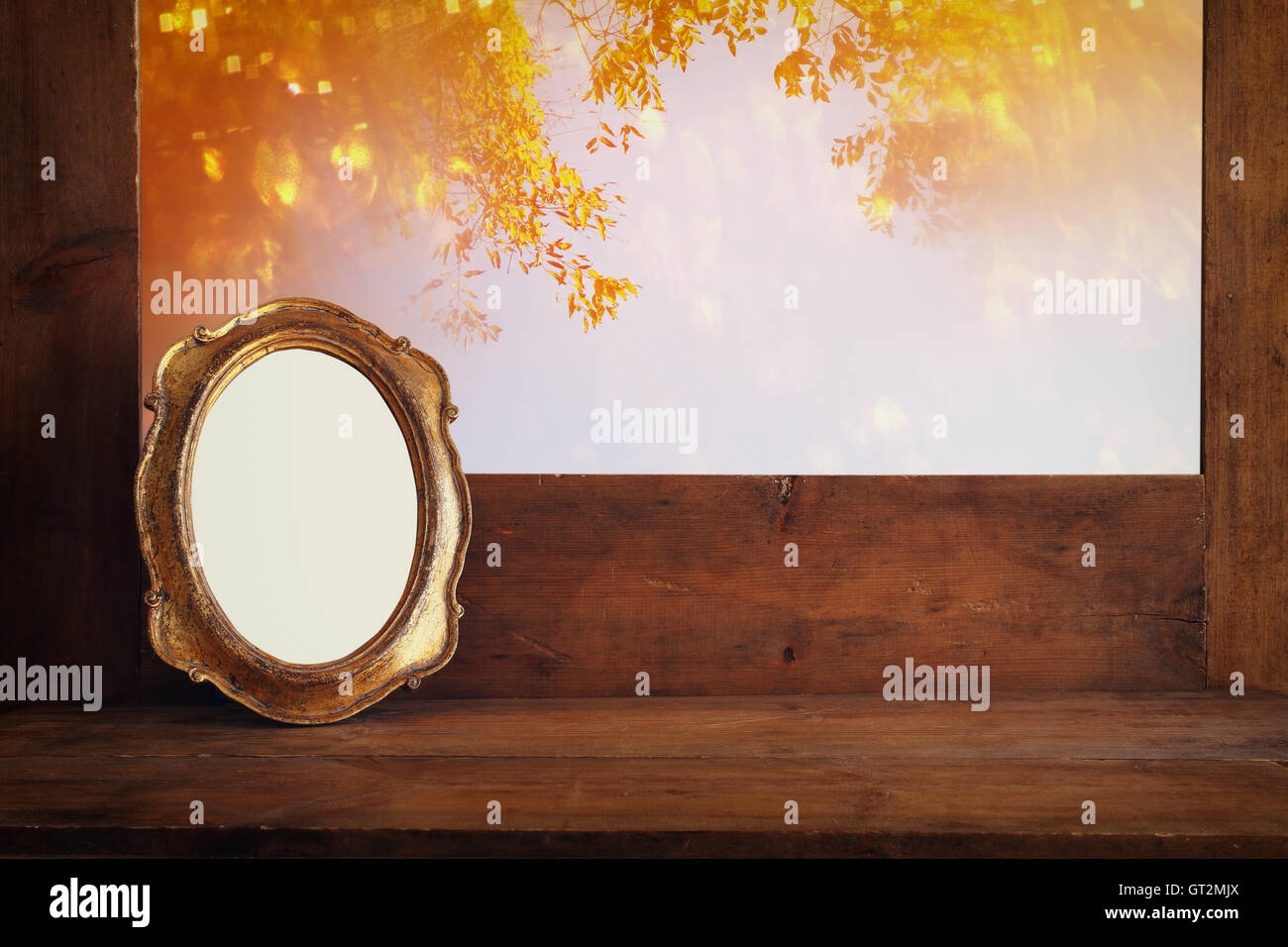 Golden old blank frame on wooden window sill Stock Photo - Alamy