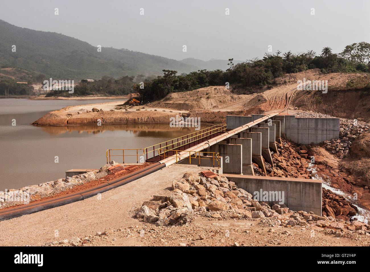 Mining operations for producing and managing iron ore. Newly built dam ...