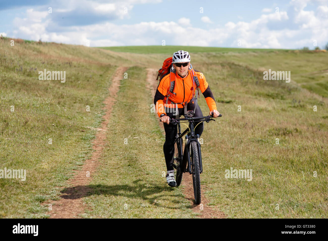 Young man traveler riding on bicycle with red backpack Stock Photo - Alamy