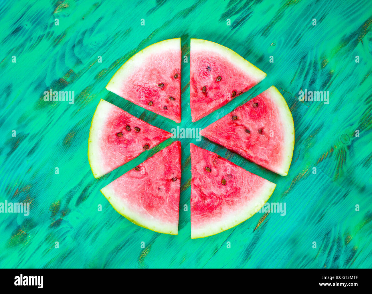 Top view of four ripe watermelon chunks isolated on a white background ...