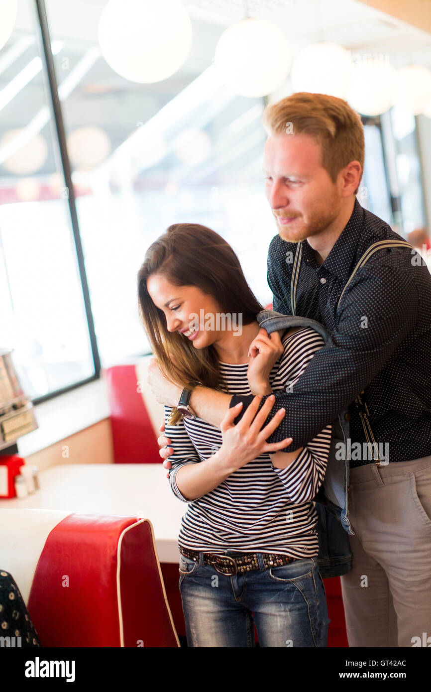 Friends eating fast food at the table in the diner Stock Photo - Alamy
