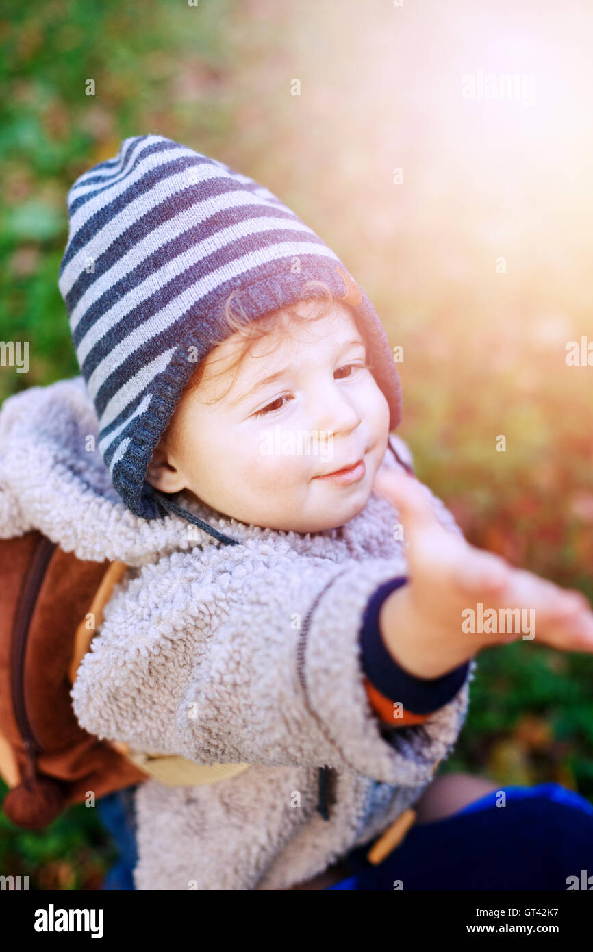 Happy kid boy in park walking outdoors, sunshine around Stock Photo - Alamy