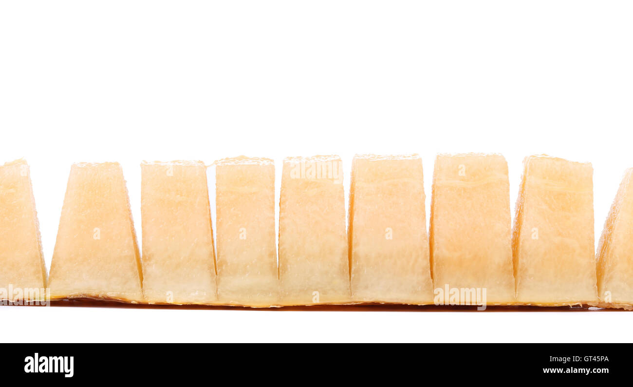 Row melon slices on a white background Stock Photo - Alamy