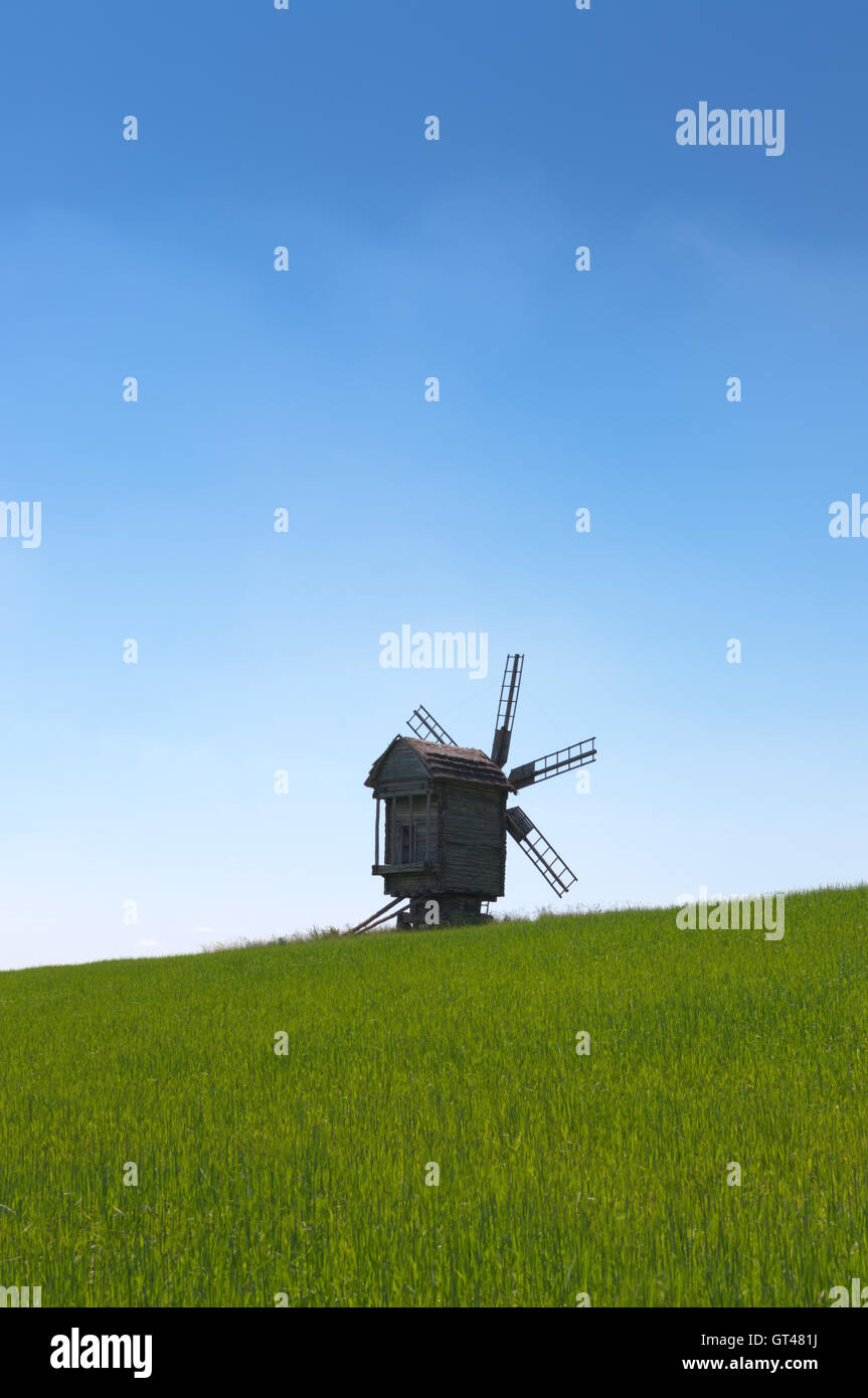 Wooden windmill in the field Stock Photo - Alamy