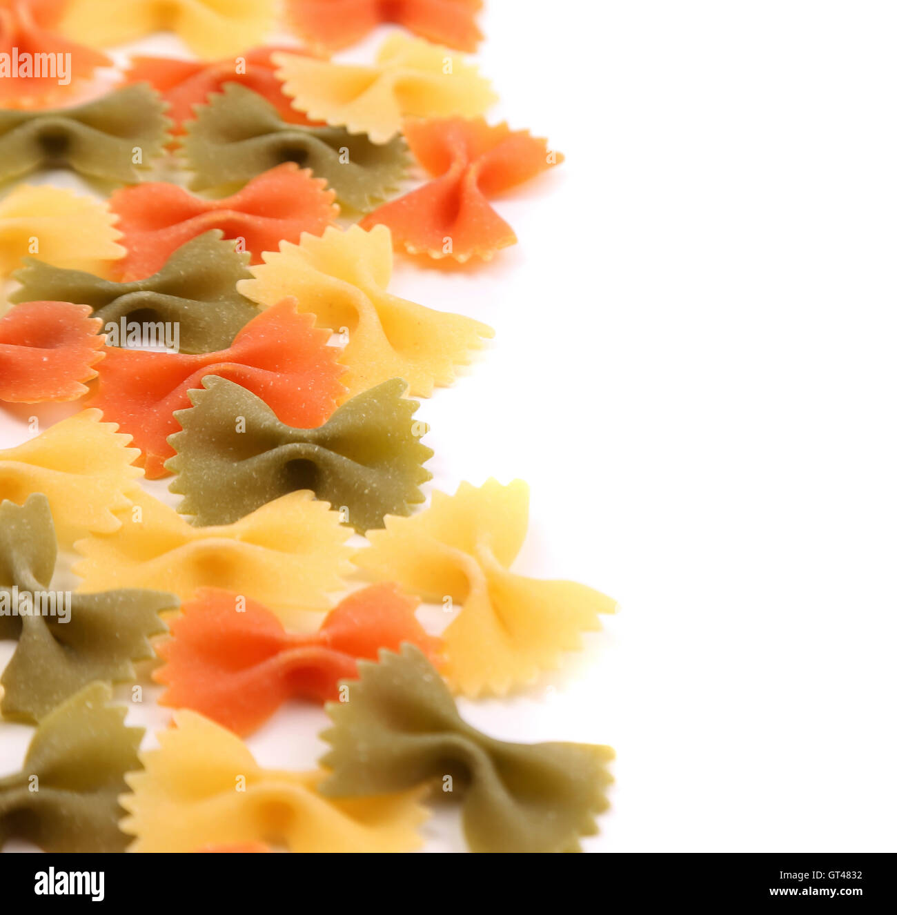 background of the farfalle pasta three colors Stock Photo - Alamy
