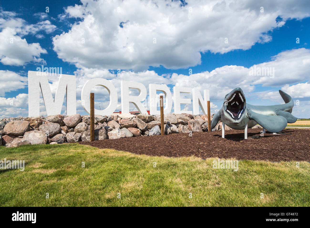 The city sign and replica of mosasaur Bruce east of Morden, Manitoba ...