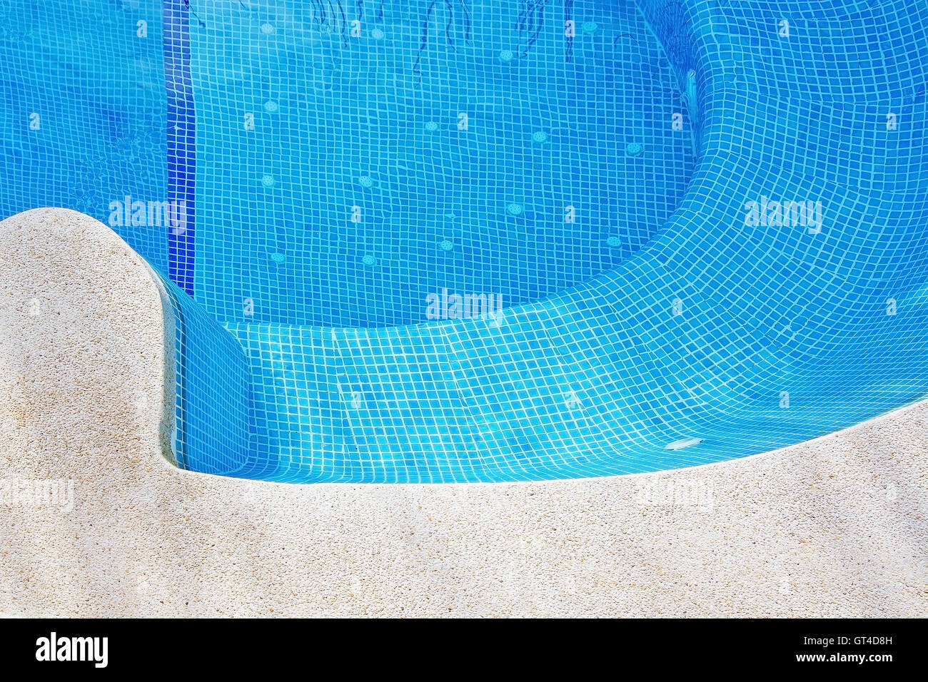 Swimming pool background with concrete, stones and blue tiles in a ...