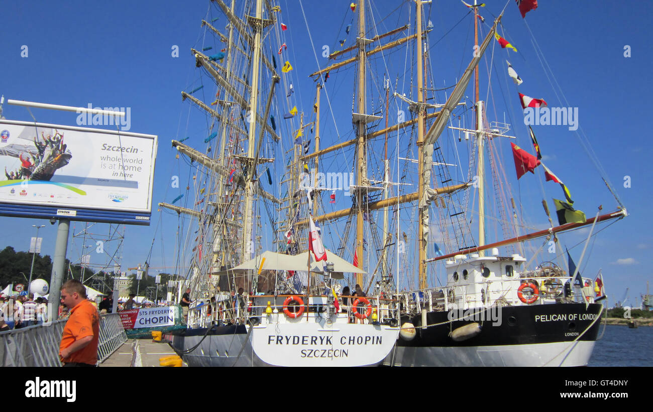 Sailing ship with lowered sails docked in port Stock Photo - Alamy
