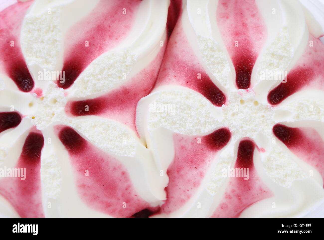 White ice cream shaped star and red syrop Stock Photo - Alamy