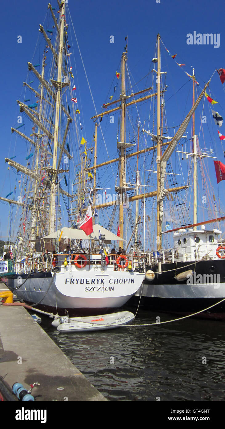 Sailing ship with lowered sails docked in port Stock Photo - Alamy