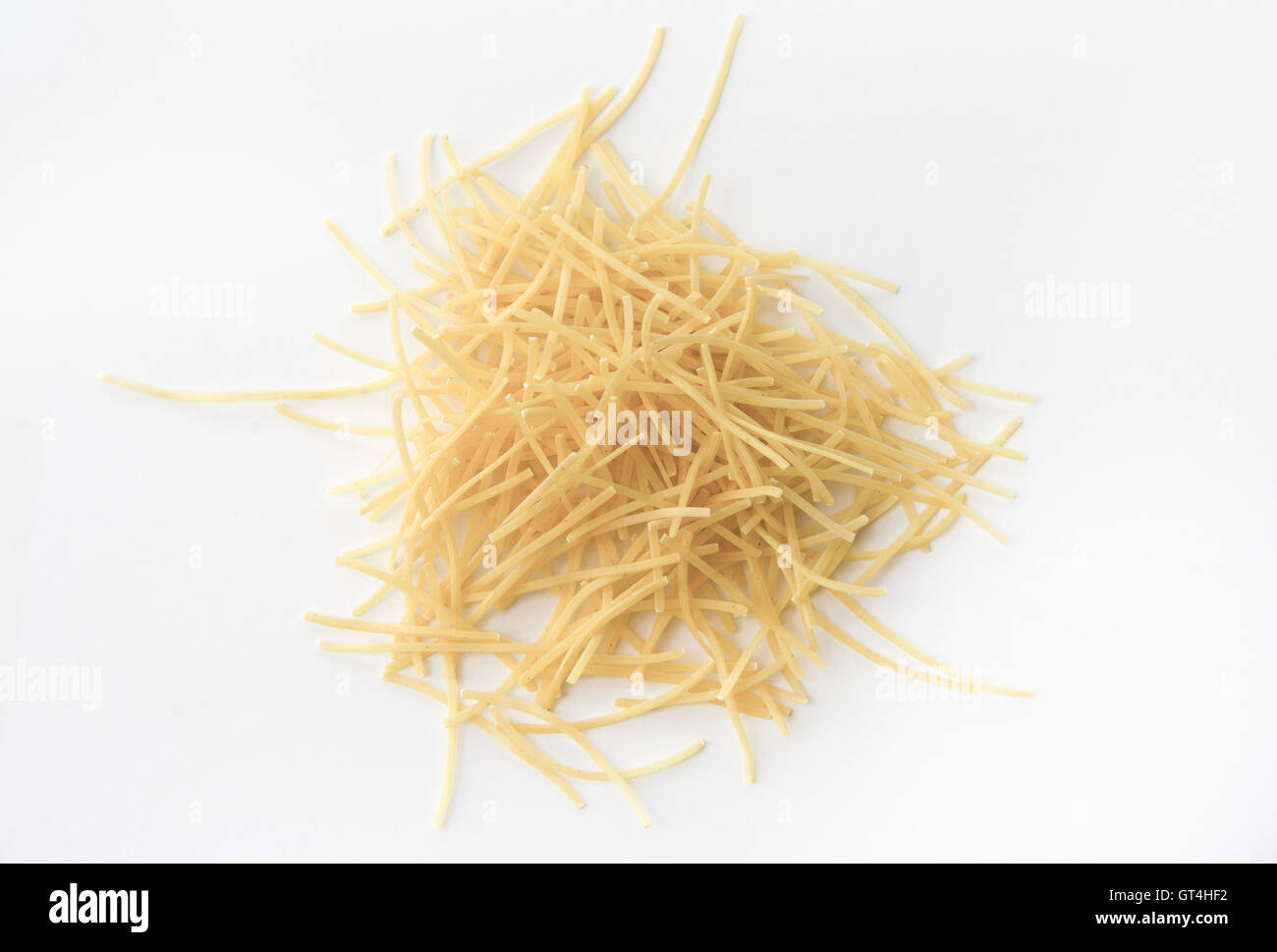 Small dry pasta noodles on white background Stock Photo - Alamy