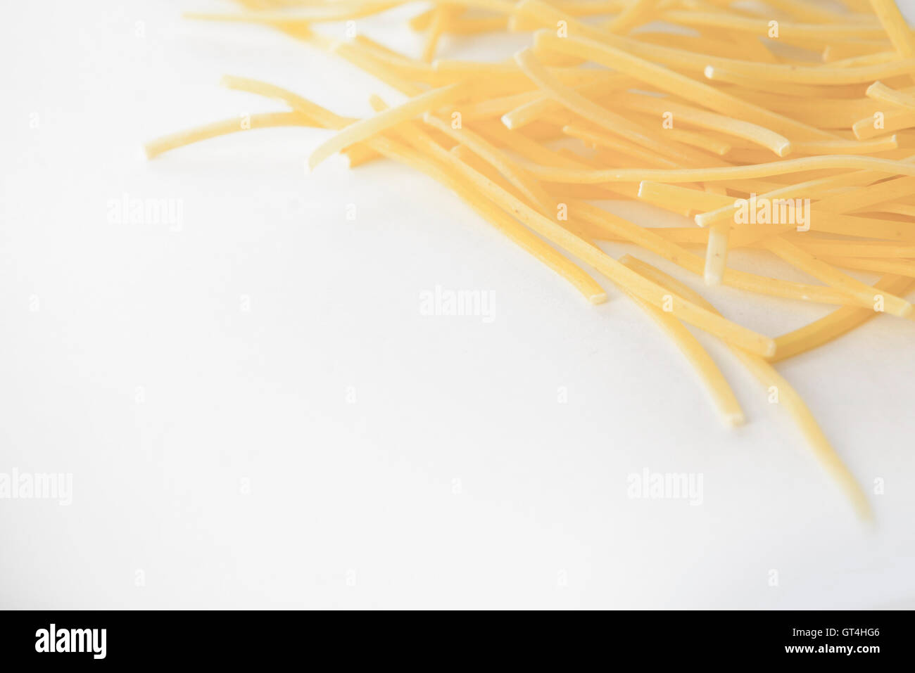 Small dry pasta noodles on white background Stock Photo - Alamy