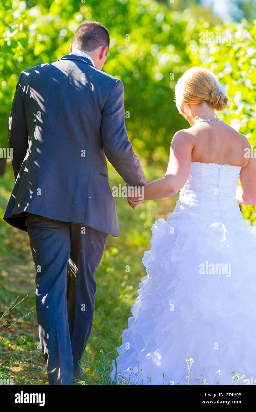 Bride and Groom Walking Away Stock Photo - Alamy