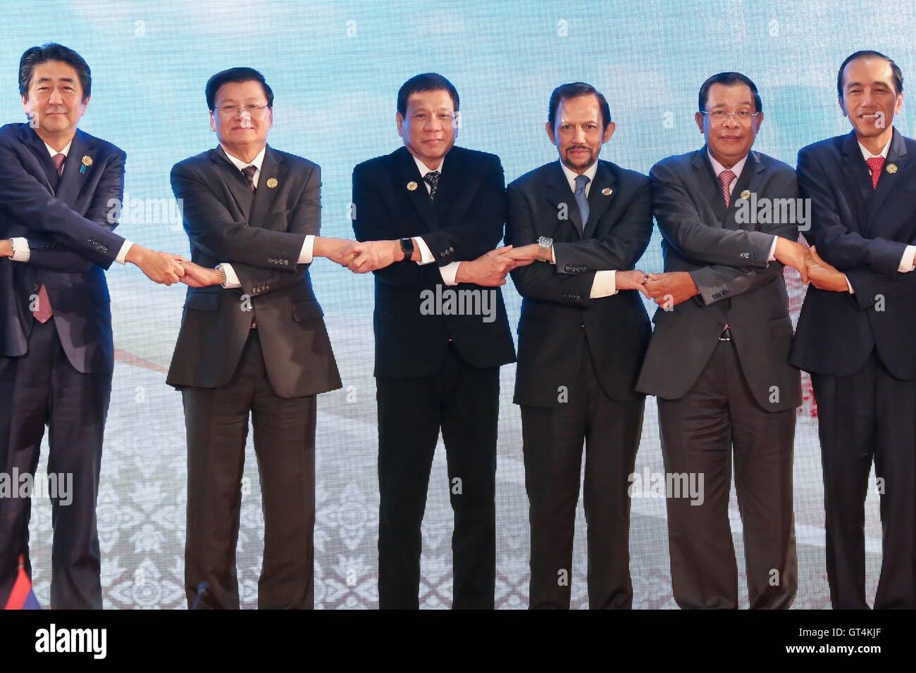 Philippine President Rodrigo Duterte, center, joins hands with other ...