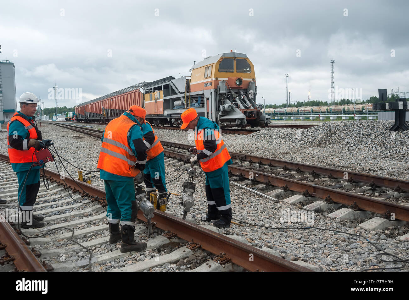 Railway workers repairing rail Stock Photo - Alamy