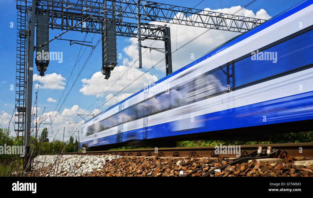 Modern electric passenger train moving on full speed Stock Photo - Alamy