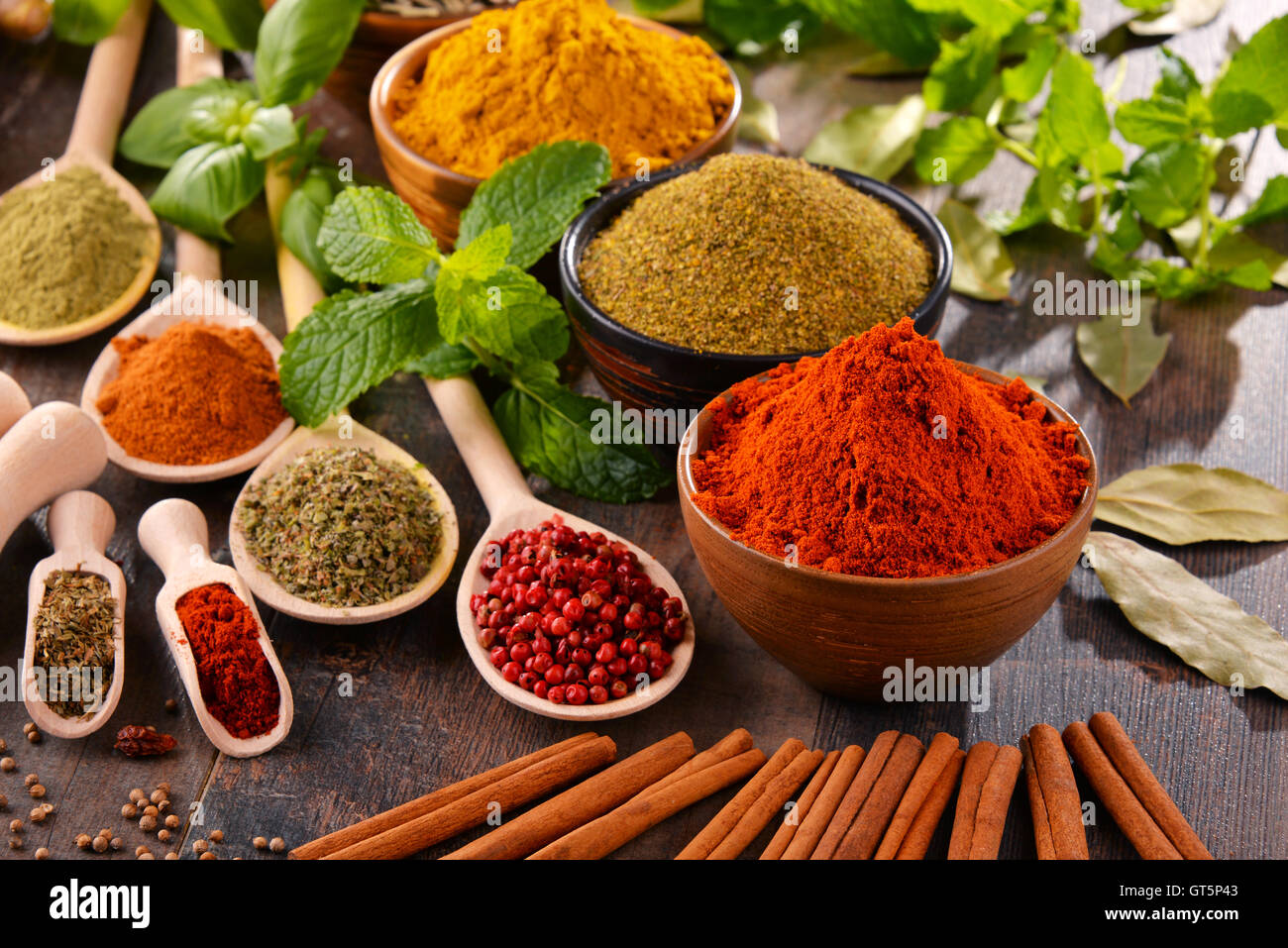 Variety of spices on kitchen table Stock Photo - Alamy