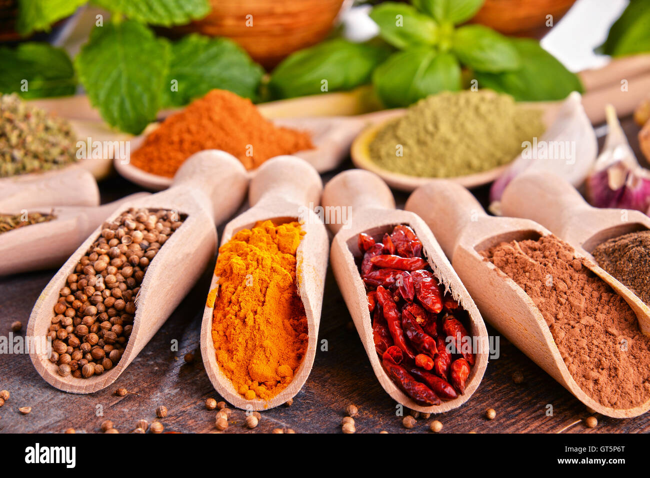Variety of spices on kitchen table Stock Photo - Alamy