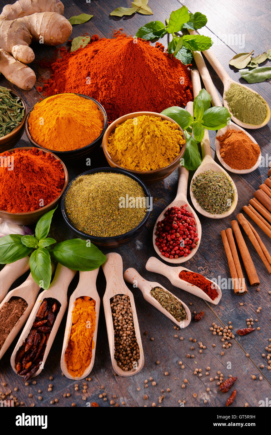 Variety of spices on kitchen table Stock Photo - Alamy