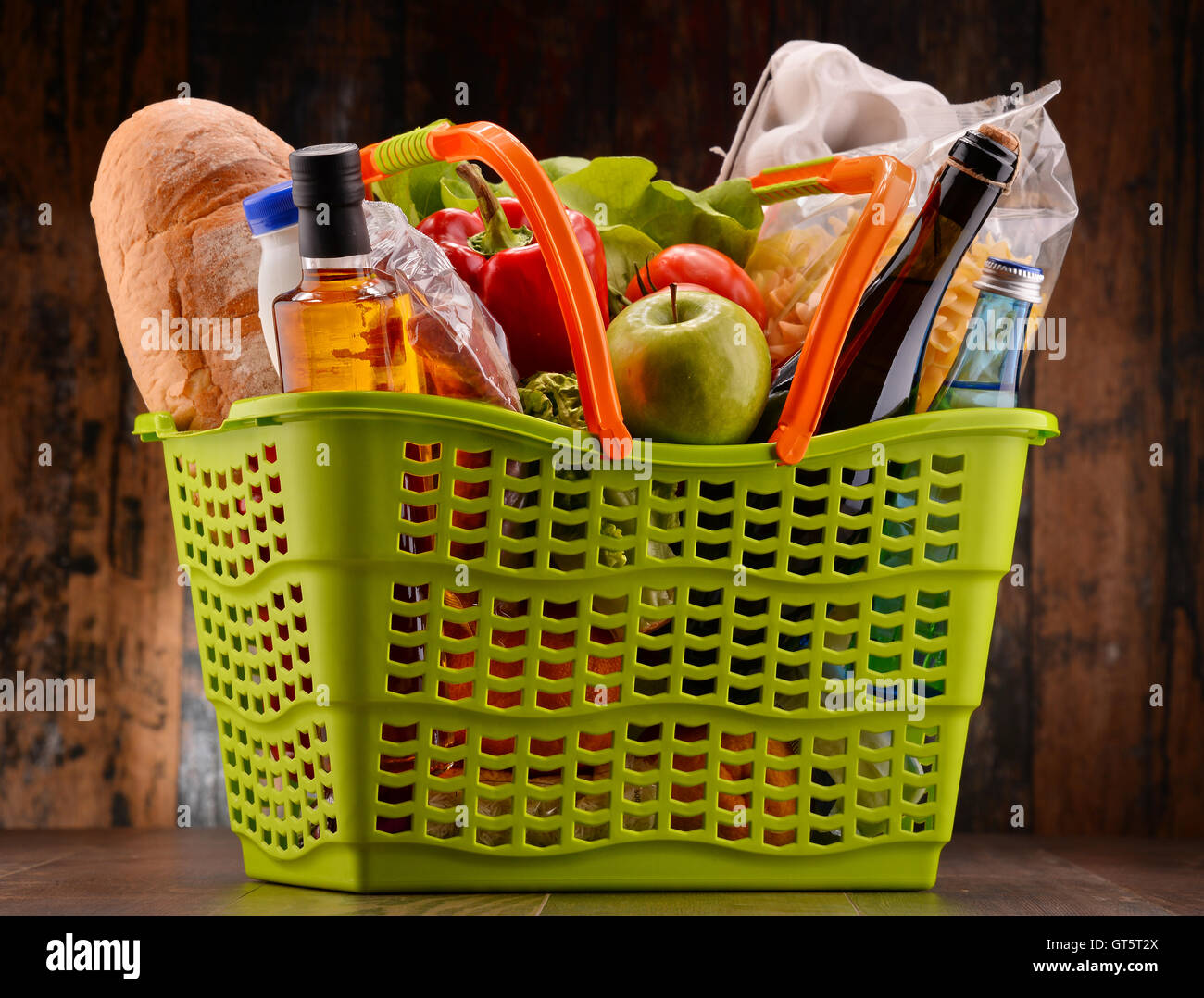 Plastic shopping basket with assorted gorcery products Stock Photo - Alamy