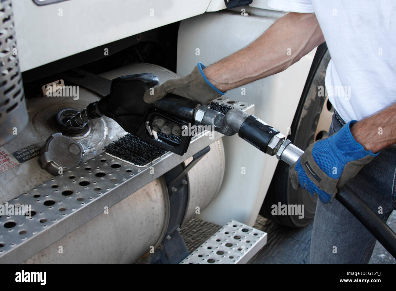 Man filling fuel tank of a truck Stock Photo - Alamy