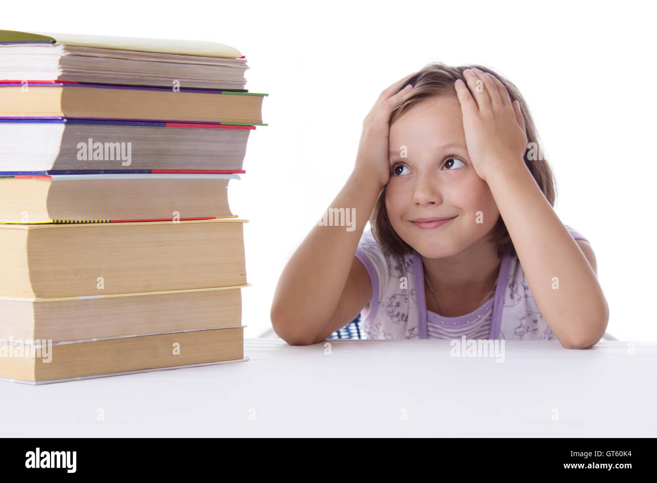 Stressed schoolgirl with pile of books Stock Photo - Alamy