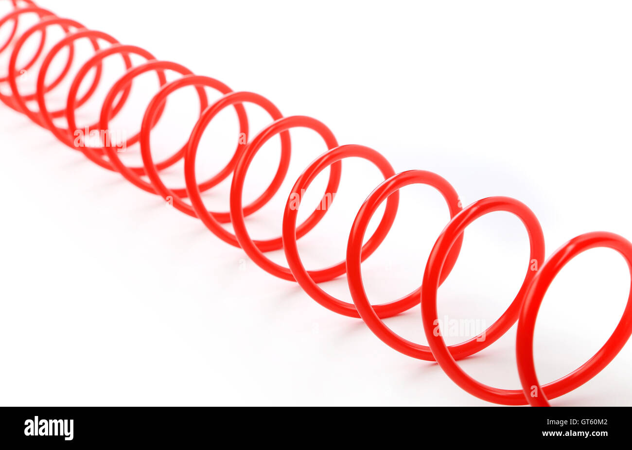 Plastic spring isolated on a white background Stock Photo - Alamy