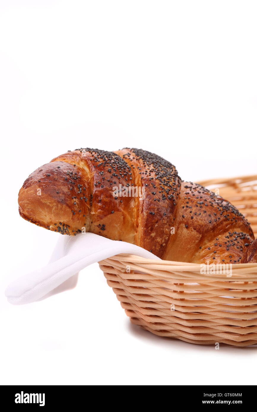 Appetizing croissants with poppy in basket Stock Photo - Alamy
