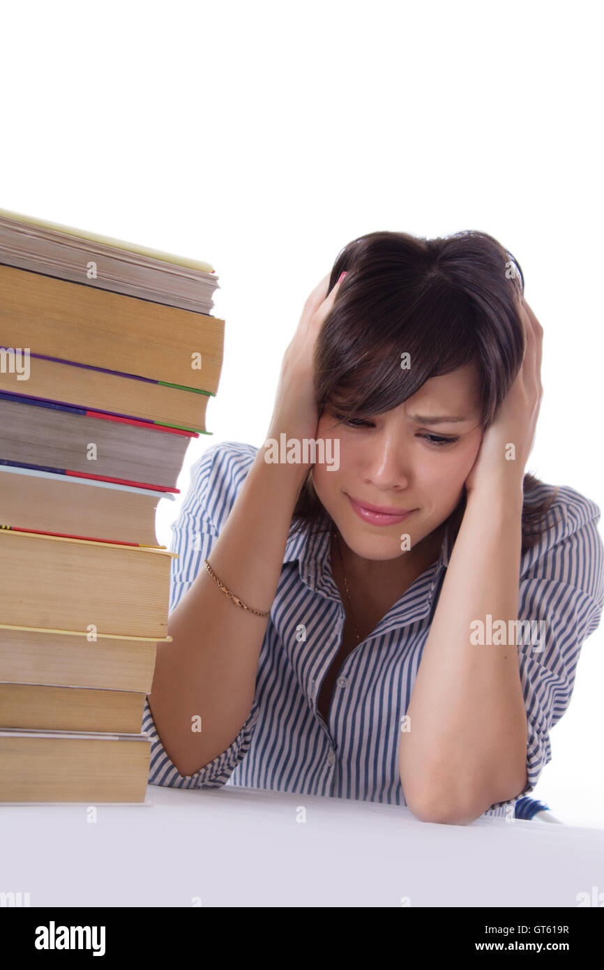 Stressed student girl with pile of books Stock Photo - Alamy