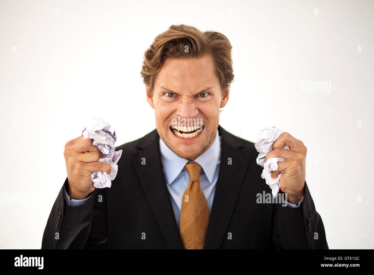 Angry businessman crumbles paper Stock Photo - Alamy