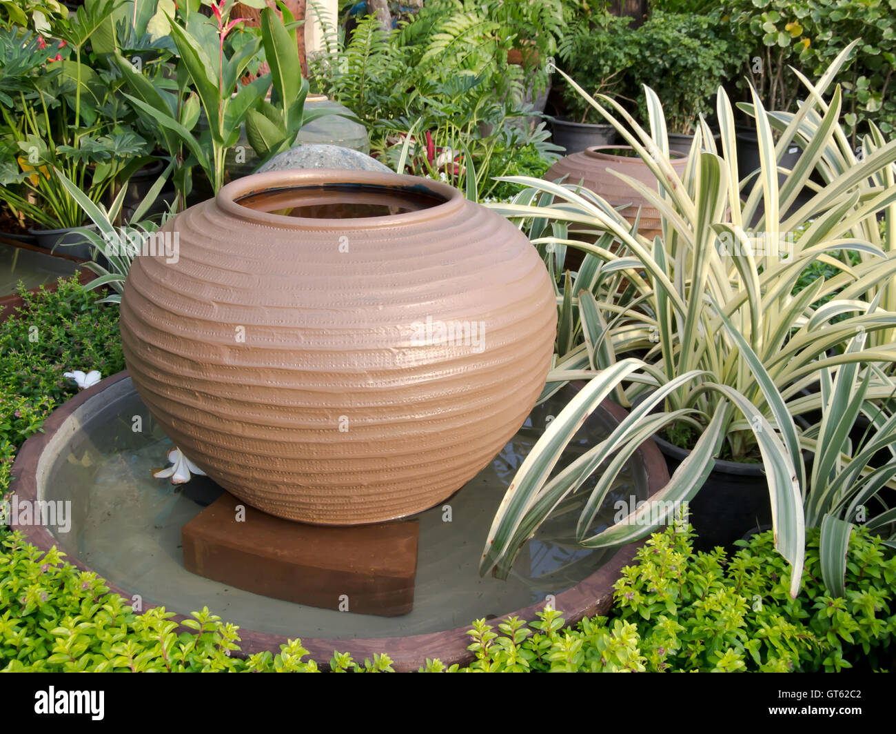 water jar in garden Stock Photo - Alamy