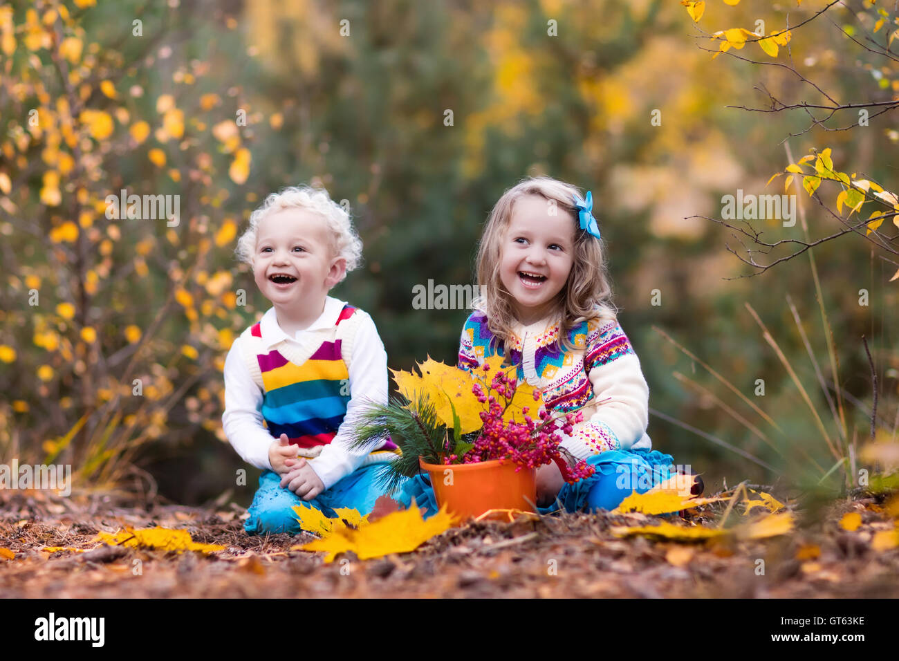 Happy children playing in beautiful autumn park on warm sunny fall day ...