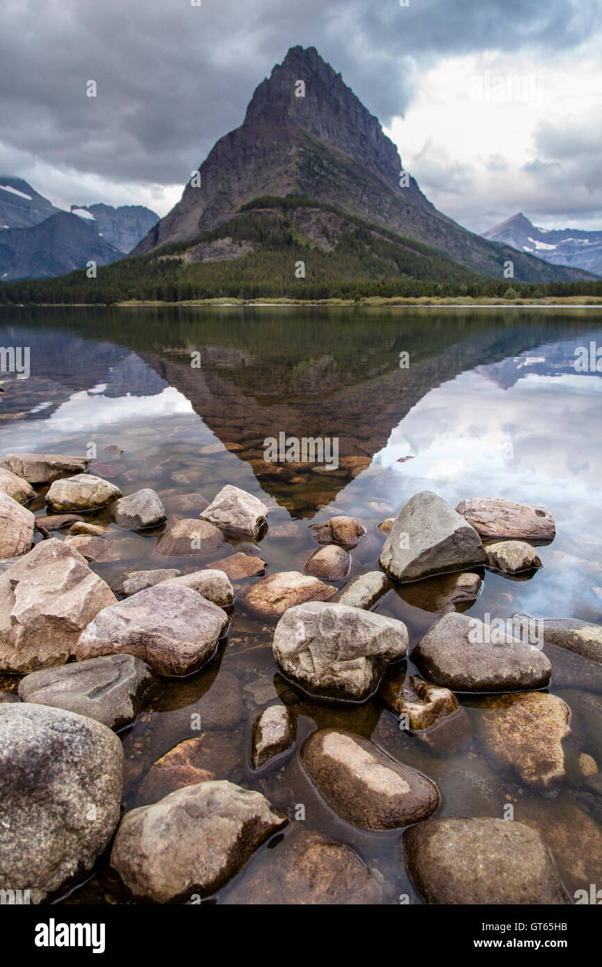 Mount Wilbur reflected in Swiftcurrent Lake at Grinnell Point just ...