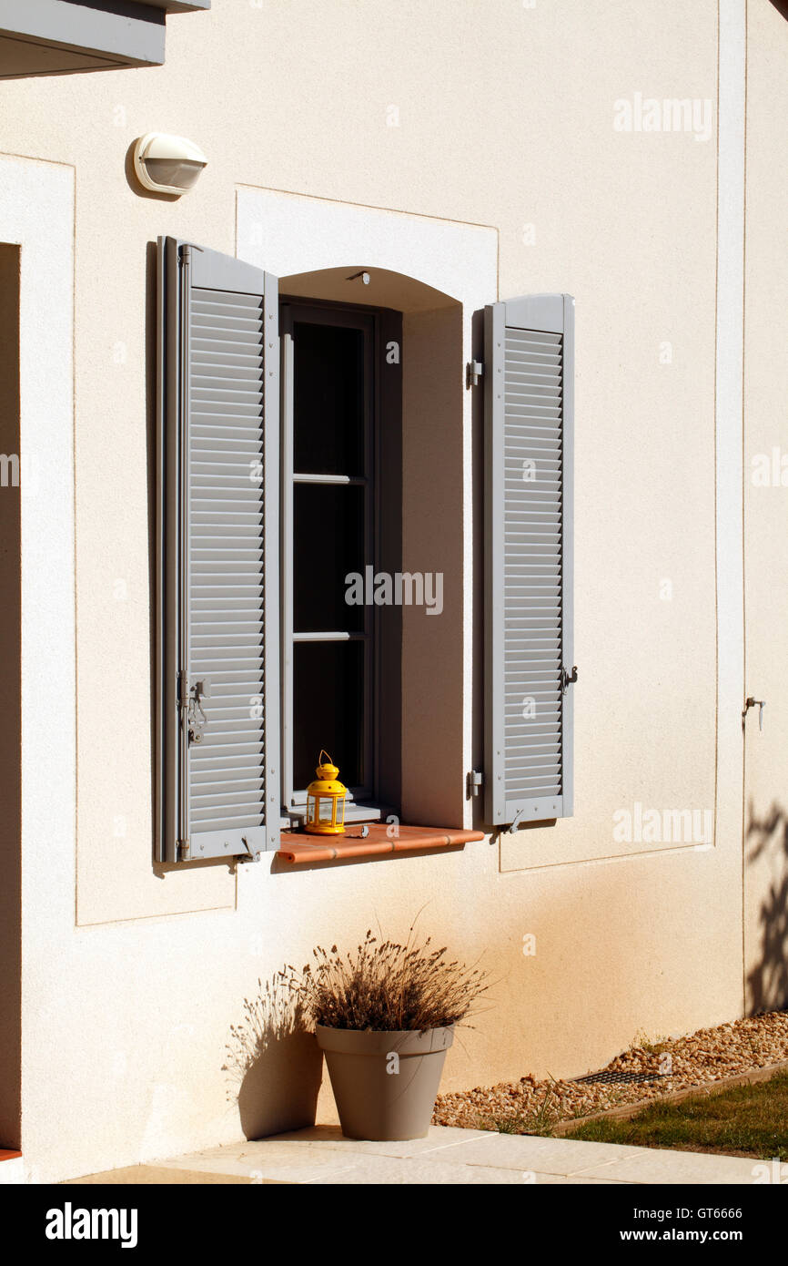 Closed shuttered windows on a whitewashed house in the sun Stock Photo ...