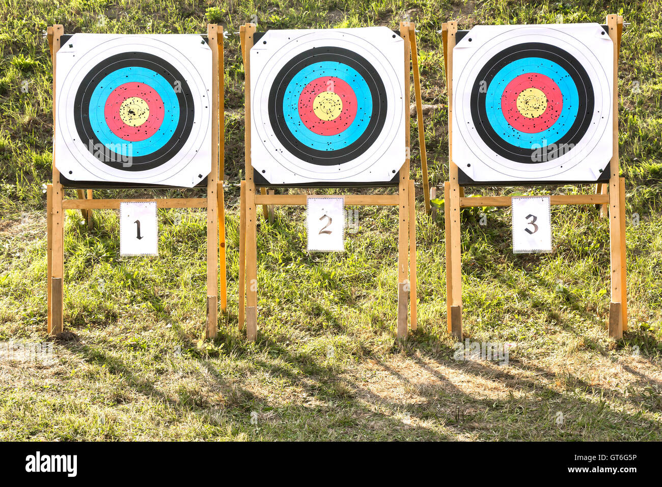 Three of paper archery targets in wooden stands Stock Photo - Alamy