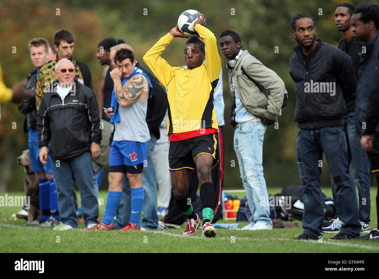 A large crowd watches as a Hackney Downs FC player takes a throw-in ...